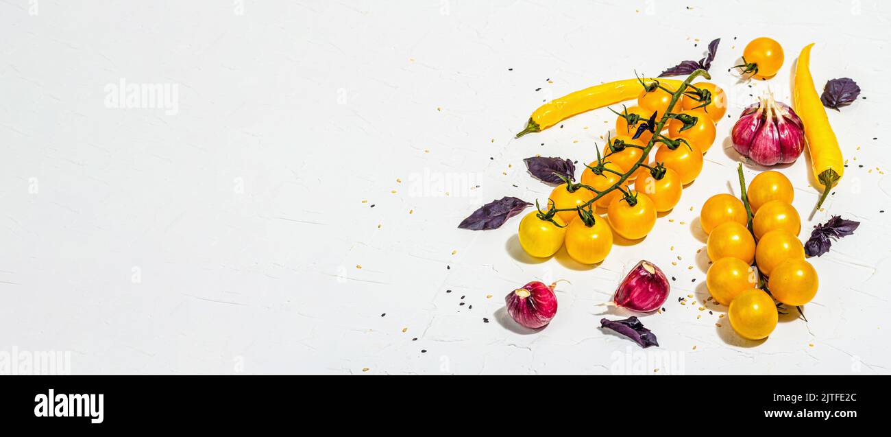 Culinary background with ripe vegetables. Yellow tomato cherries, chili ...