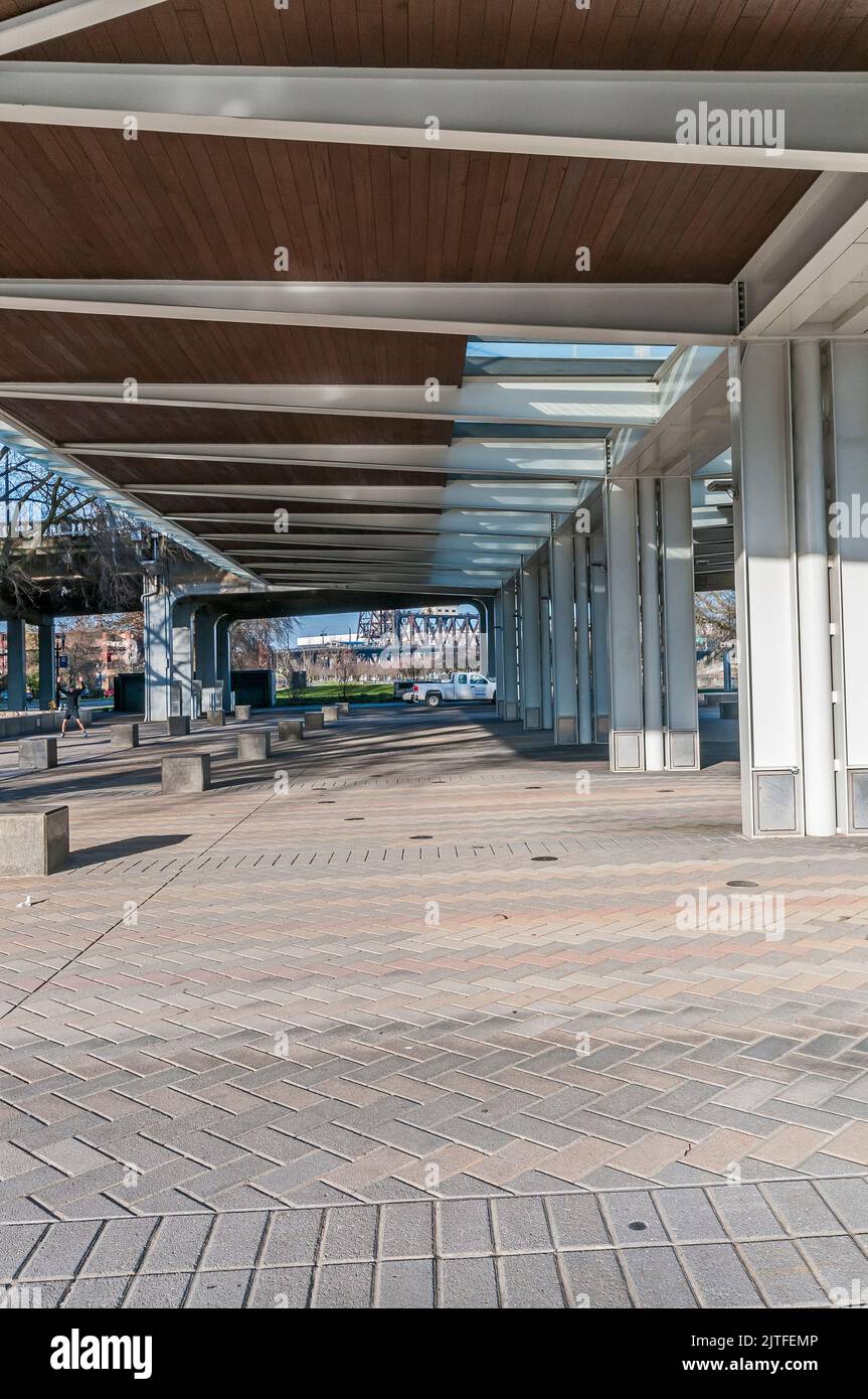 A man, at right center, exercises or stretches at Tom McCall Waterfront ...