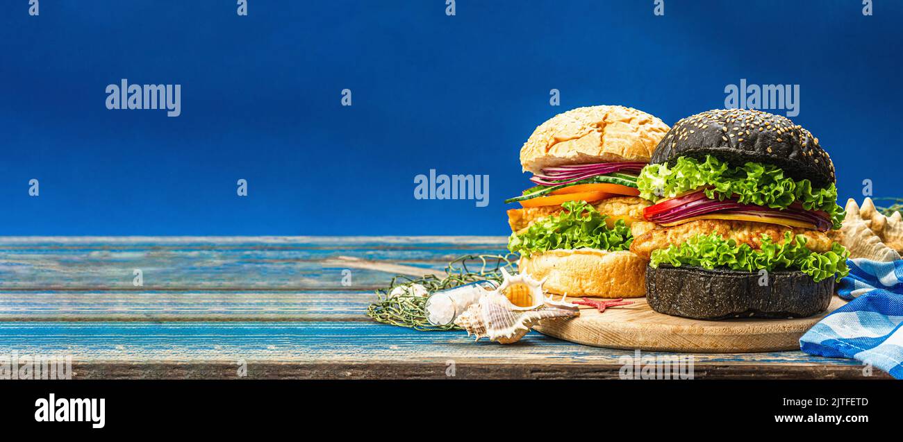 Homemade fish burgers. Fresh ingredients, ripe vegetables, fast food ...