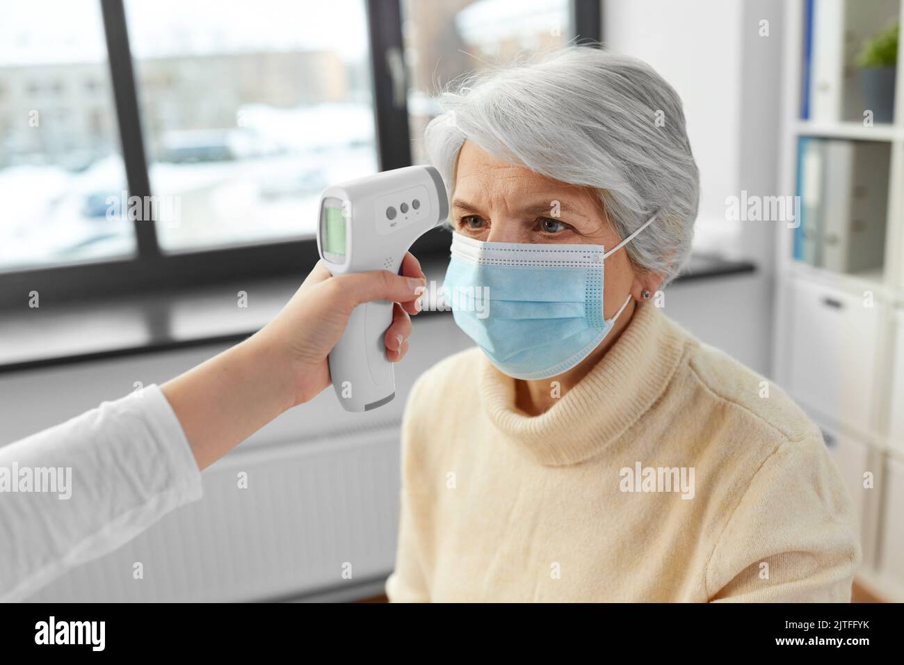 doctor with thermometer and woman at hospital Stock Photo - Alamy