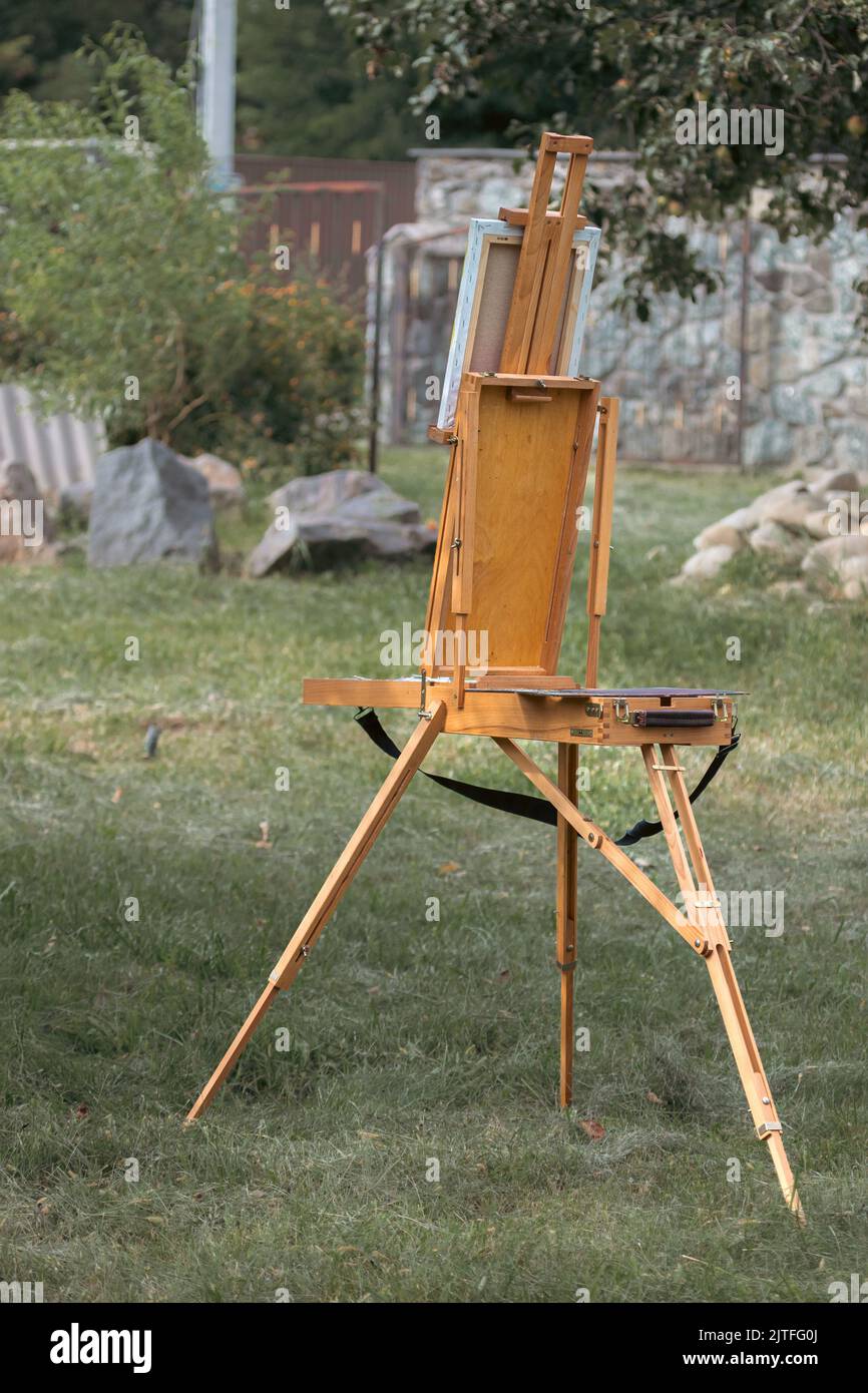 The artist's wooden easel in the garden. An artist's tool. Draw in ...