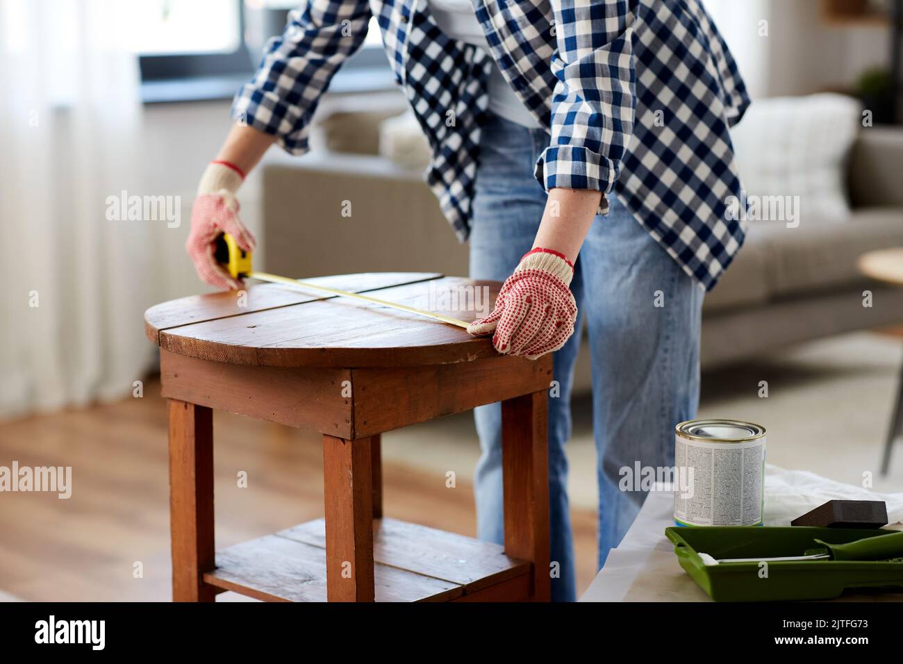 woman with ruler measuring table for renovation Stock Photo - Alamy