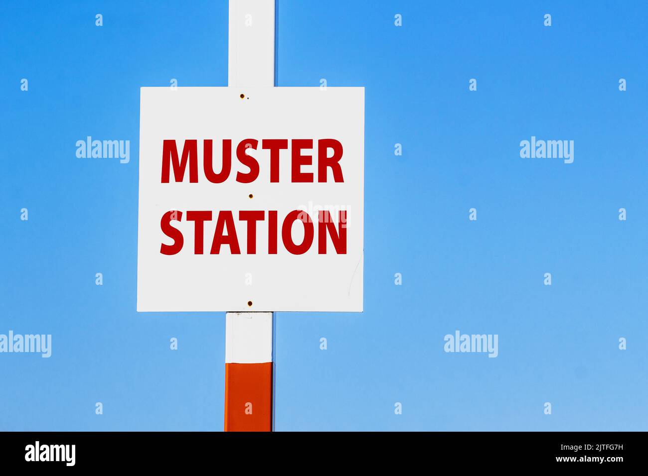 Muster station sign and blue sky with copy space Stock Photo - Alamy