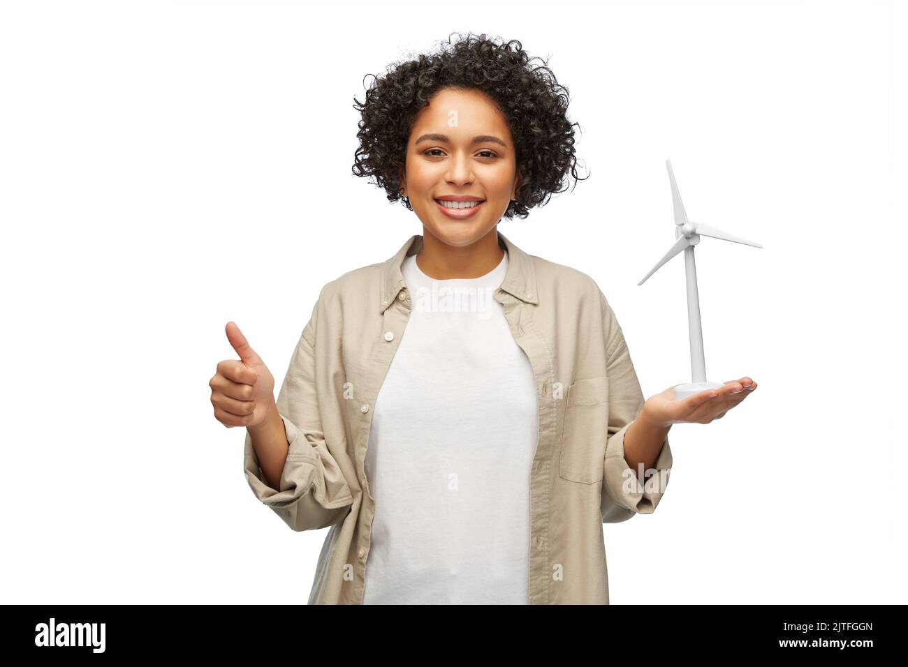 woman holding toy wind turbine showing thumbs up Stock Photo - Alamy