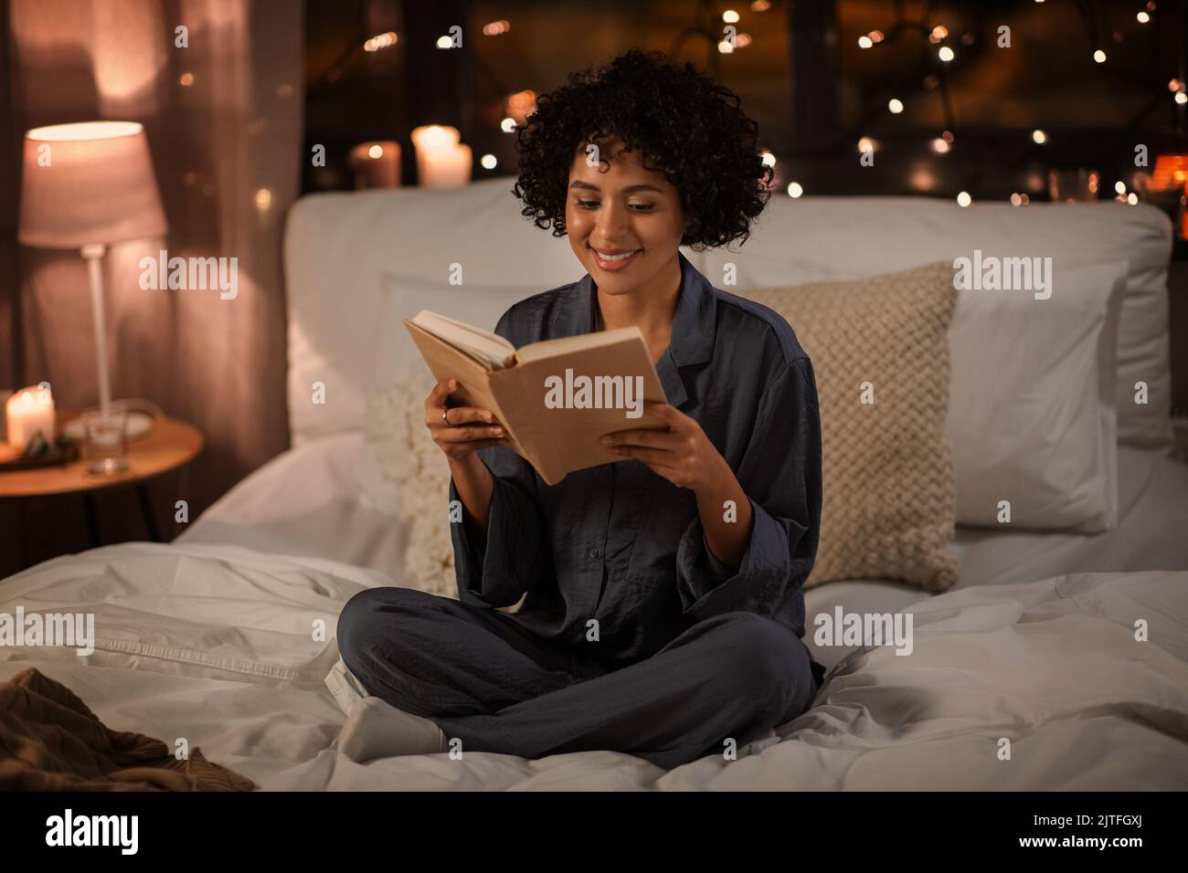 Woman reading book in bed night hi-res stock photography and images - Alamy