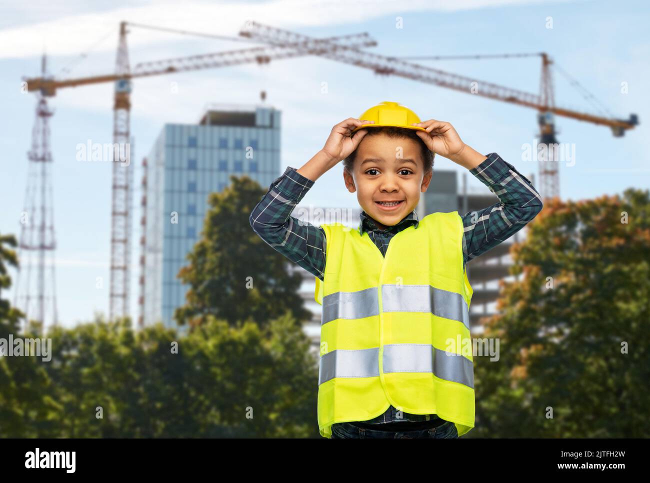 little boy in safety vest over construction site Stock Photo - Alamy