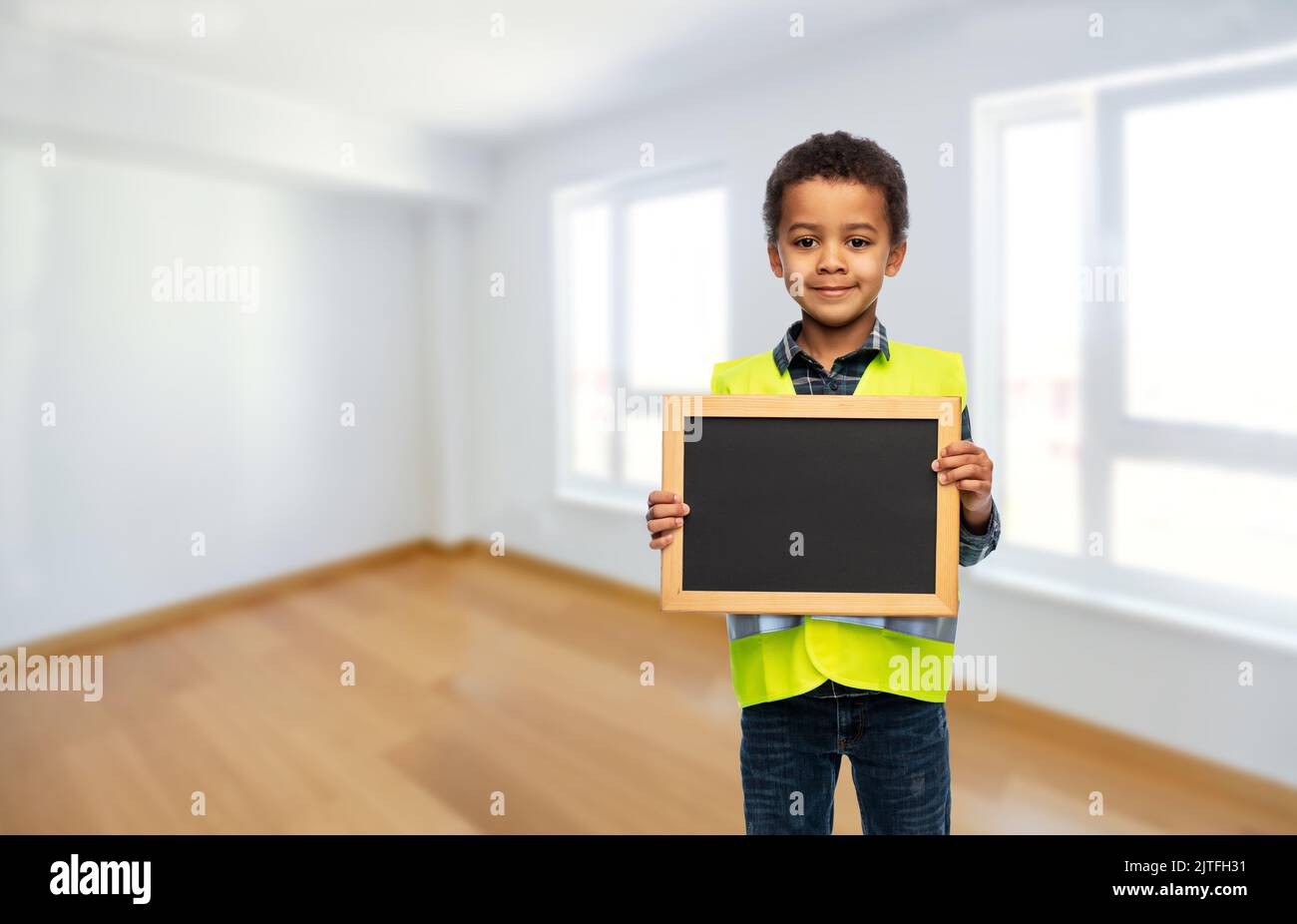 little boy with chalkboard over empty room Stock Photo - Alamy