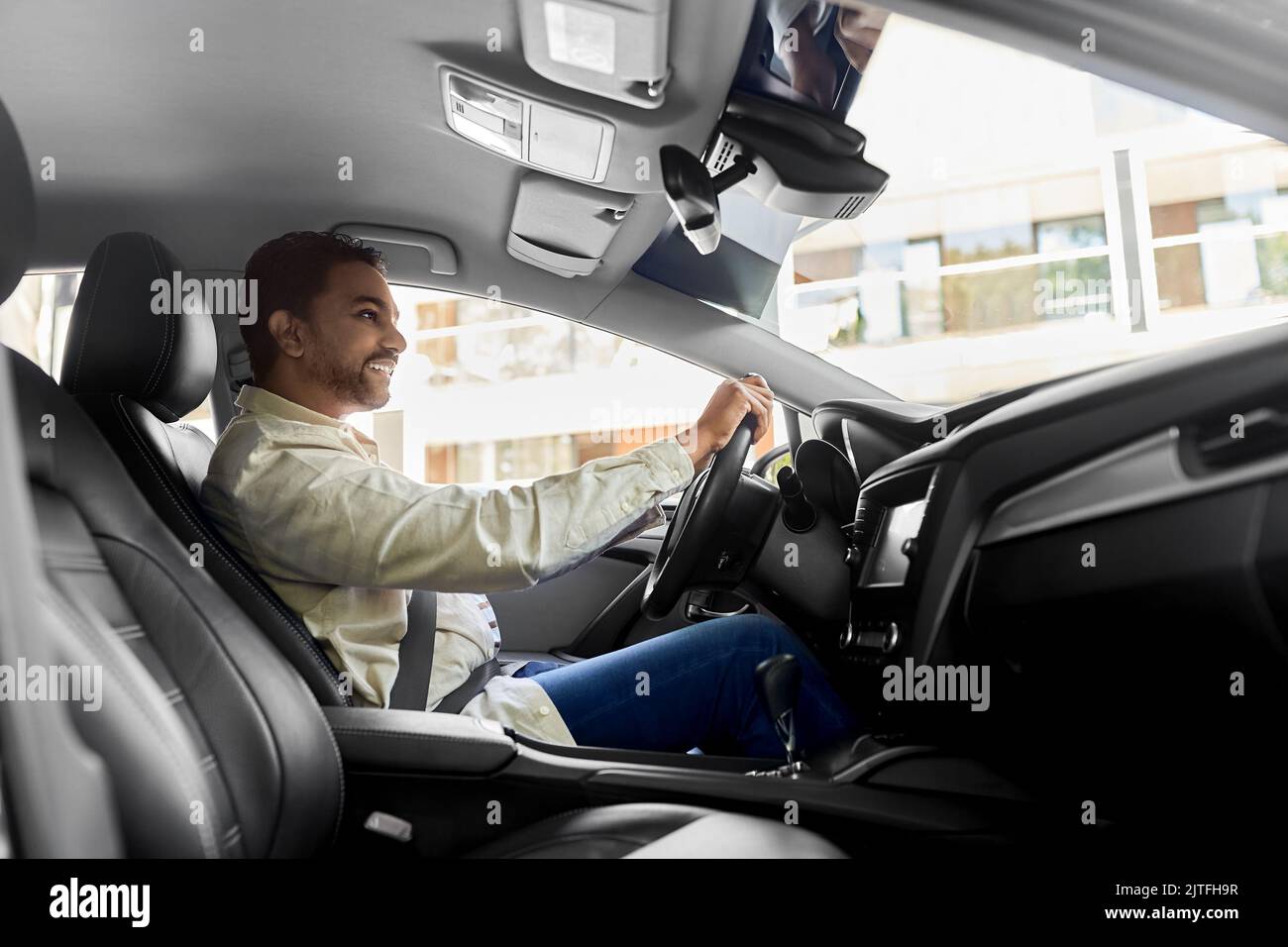smiling indian man or driver driving car Stock Photo - Alamy