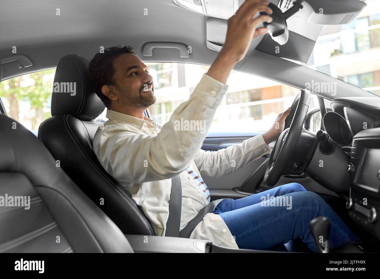 happy indian man or driver adjusting mirror in car Stock Photo - Alamy