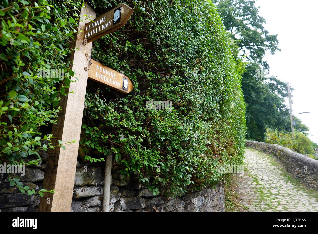 A wooden sign in Birch Vale, Derbyshire indicating Pennine Bridleway ...