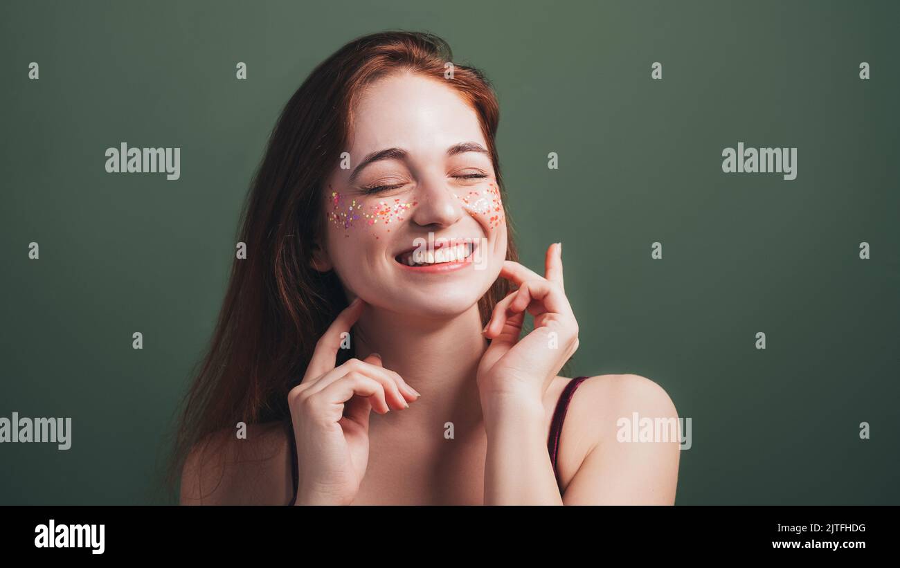 young woman awkward toothy smile eyes closed Stock Photo - Alamy