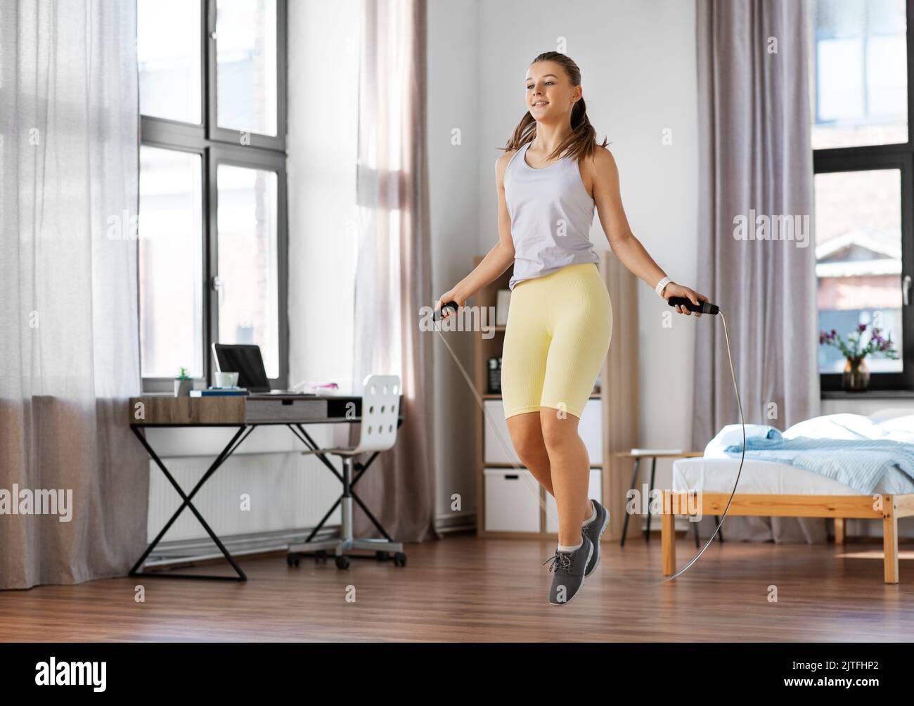 teenage girl exercising with jump rope at home Stock Photo - Alamy