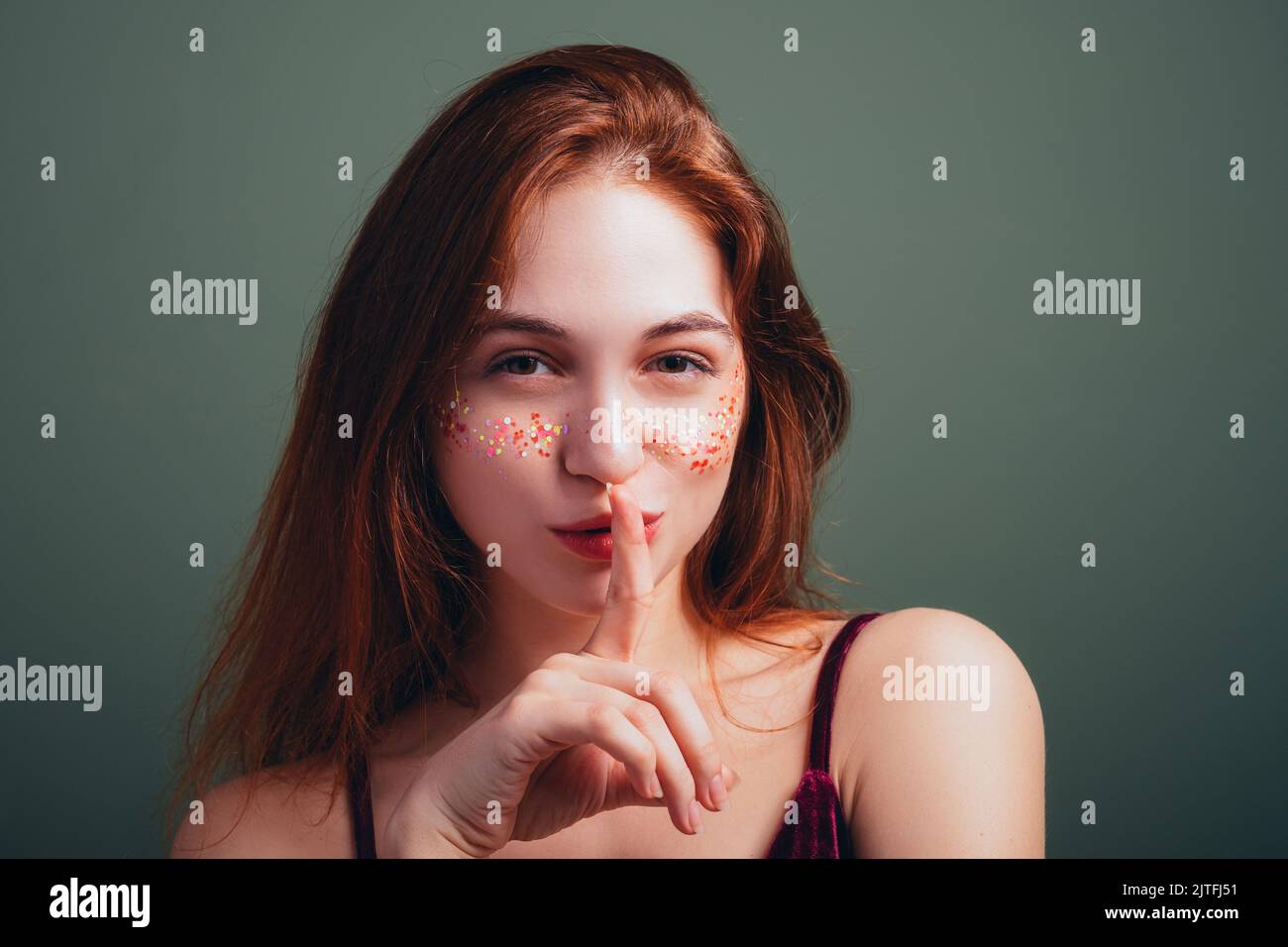 flirty young woman shush gesture sly expression Stock Photo - Alamy