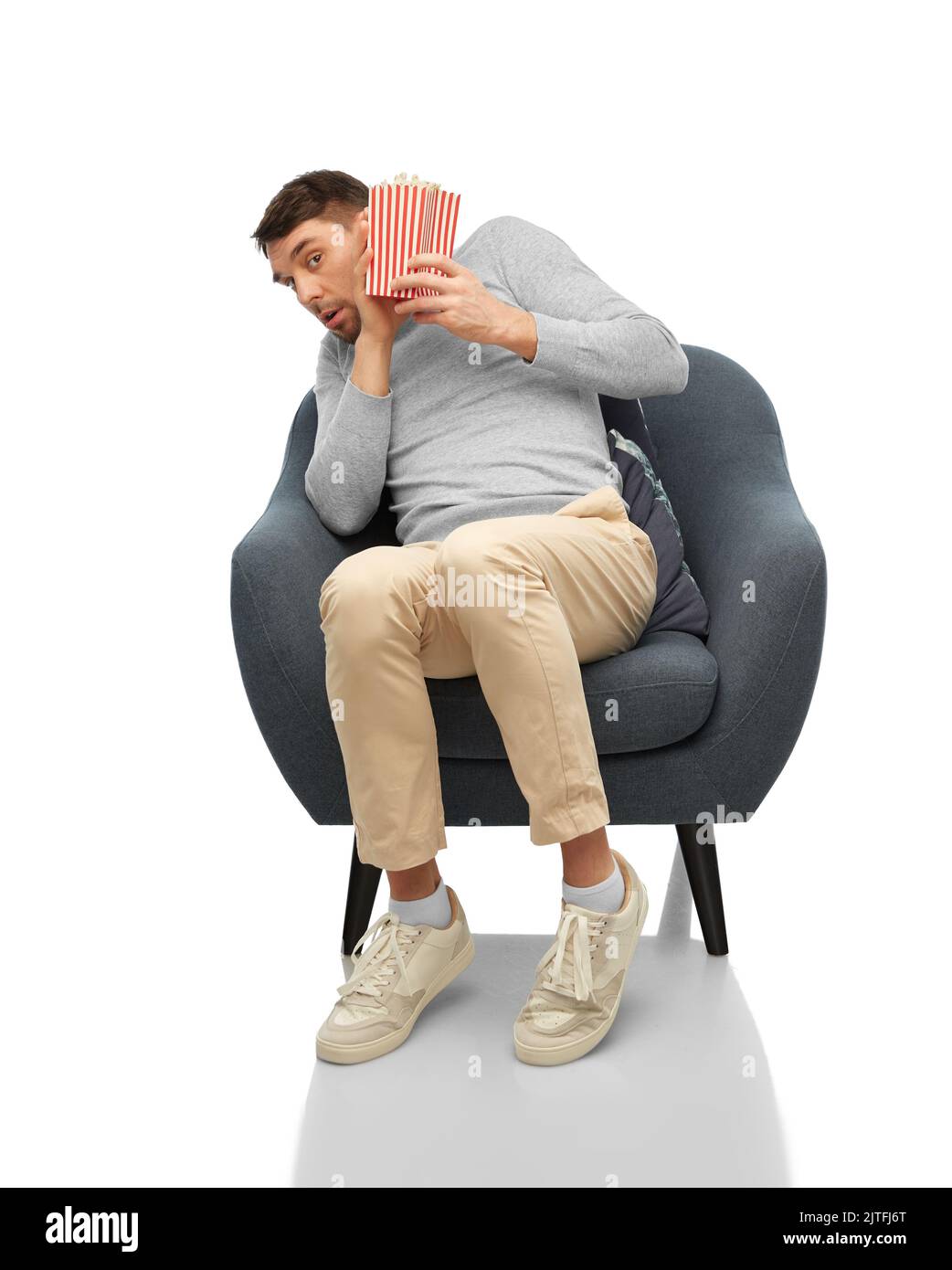 scared man with popcorn sitting in chair Stock Photo - Alamy
