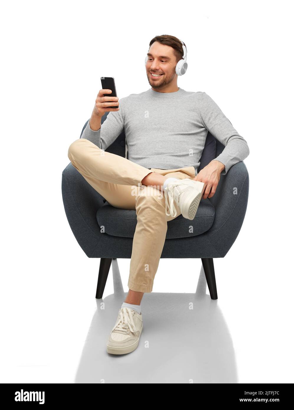 man with phone and headphones sitting in chair Stock Photo - Alamy