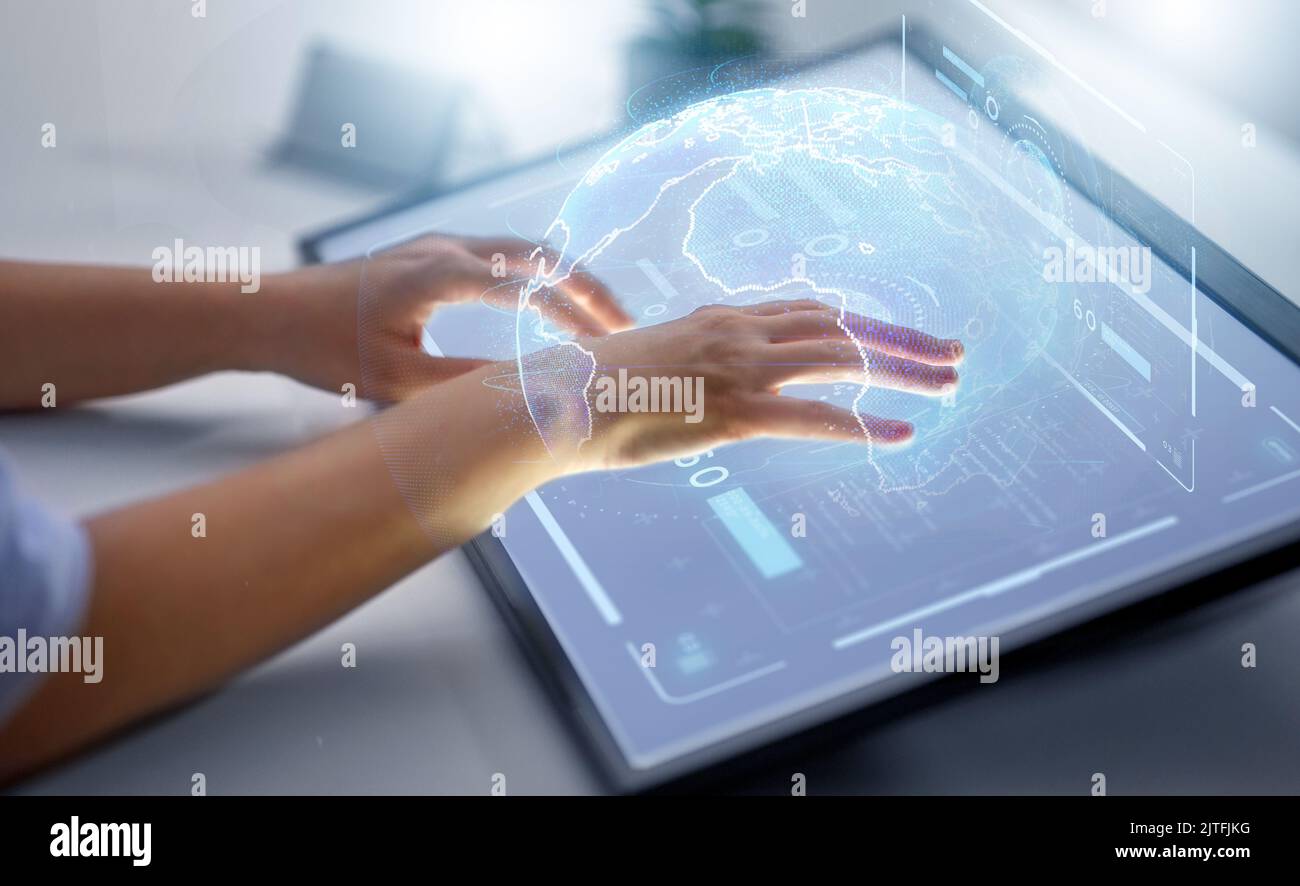 hands on led light tablet with earth hologram Stock Photo - Alamy