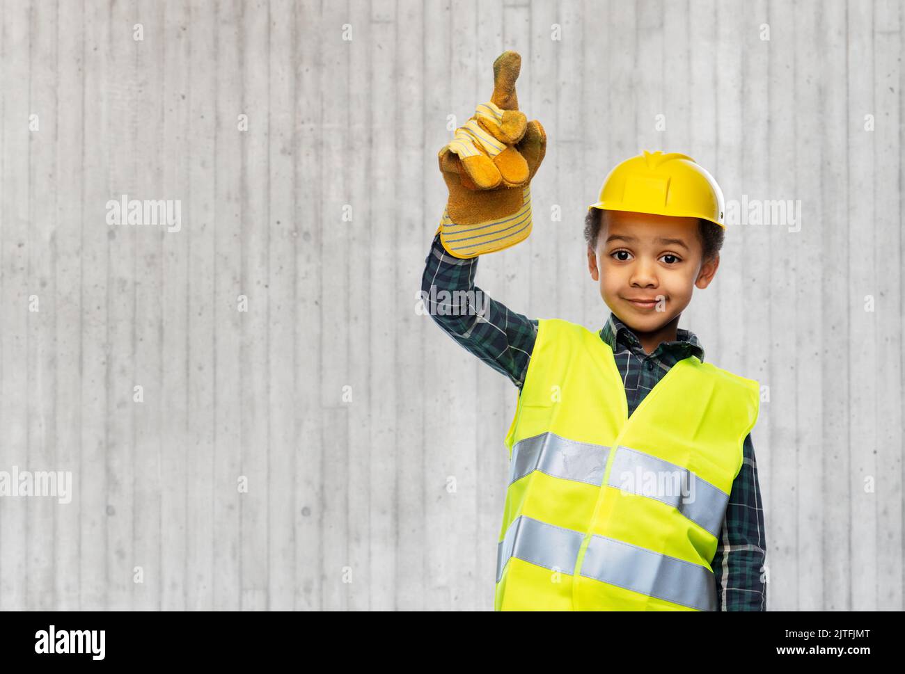 boy in construction helmet pointing finger up Stock Photo - Alamy