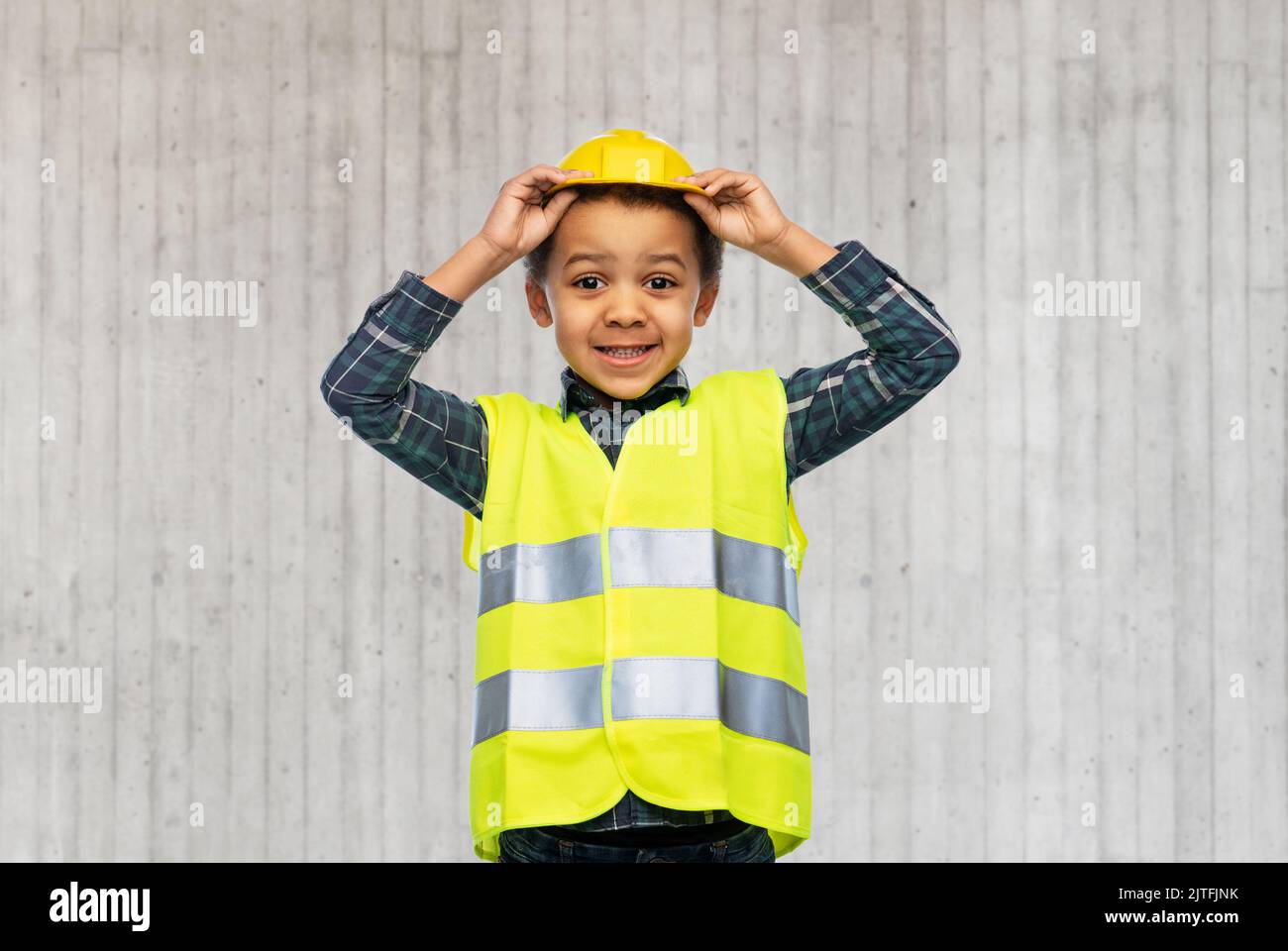 little boy in safety vest and construction helmet Stock Photo - Alamy