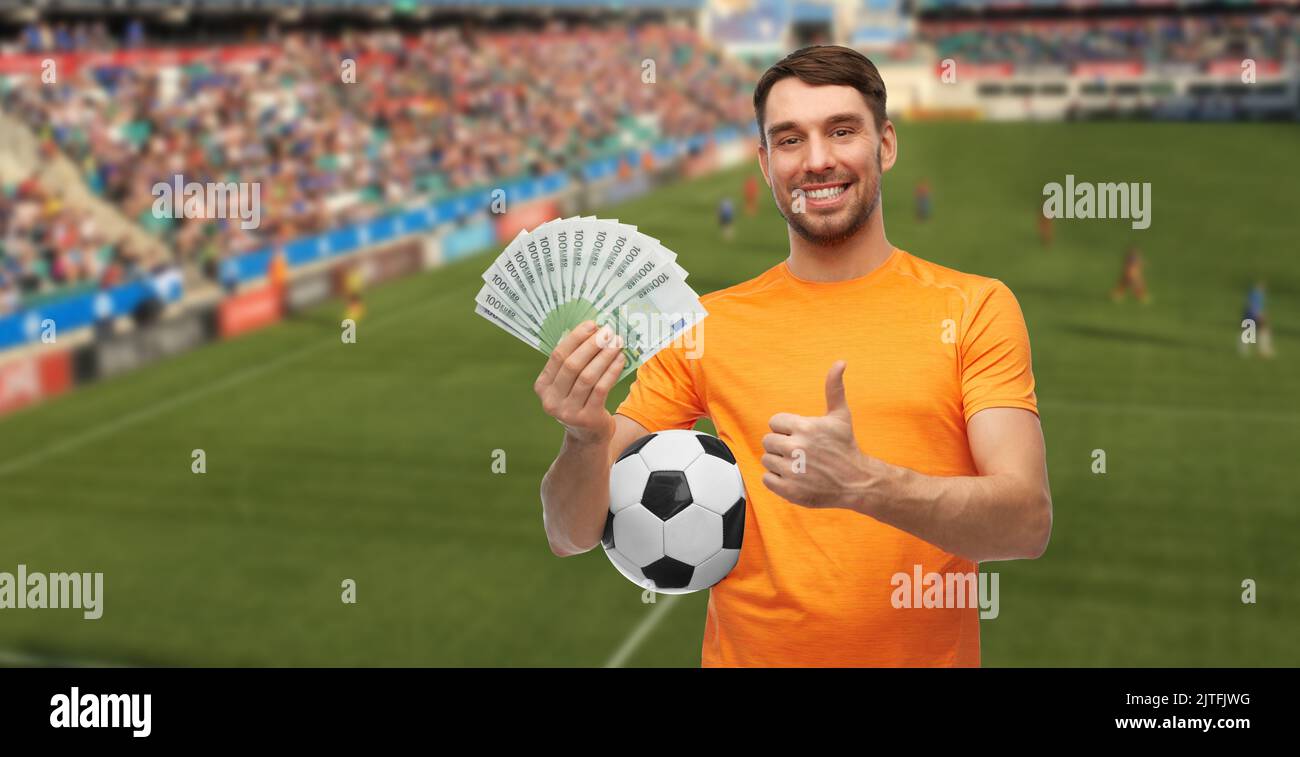 happy football fan with soccer ball and money Stock Photo - Alamy