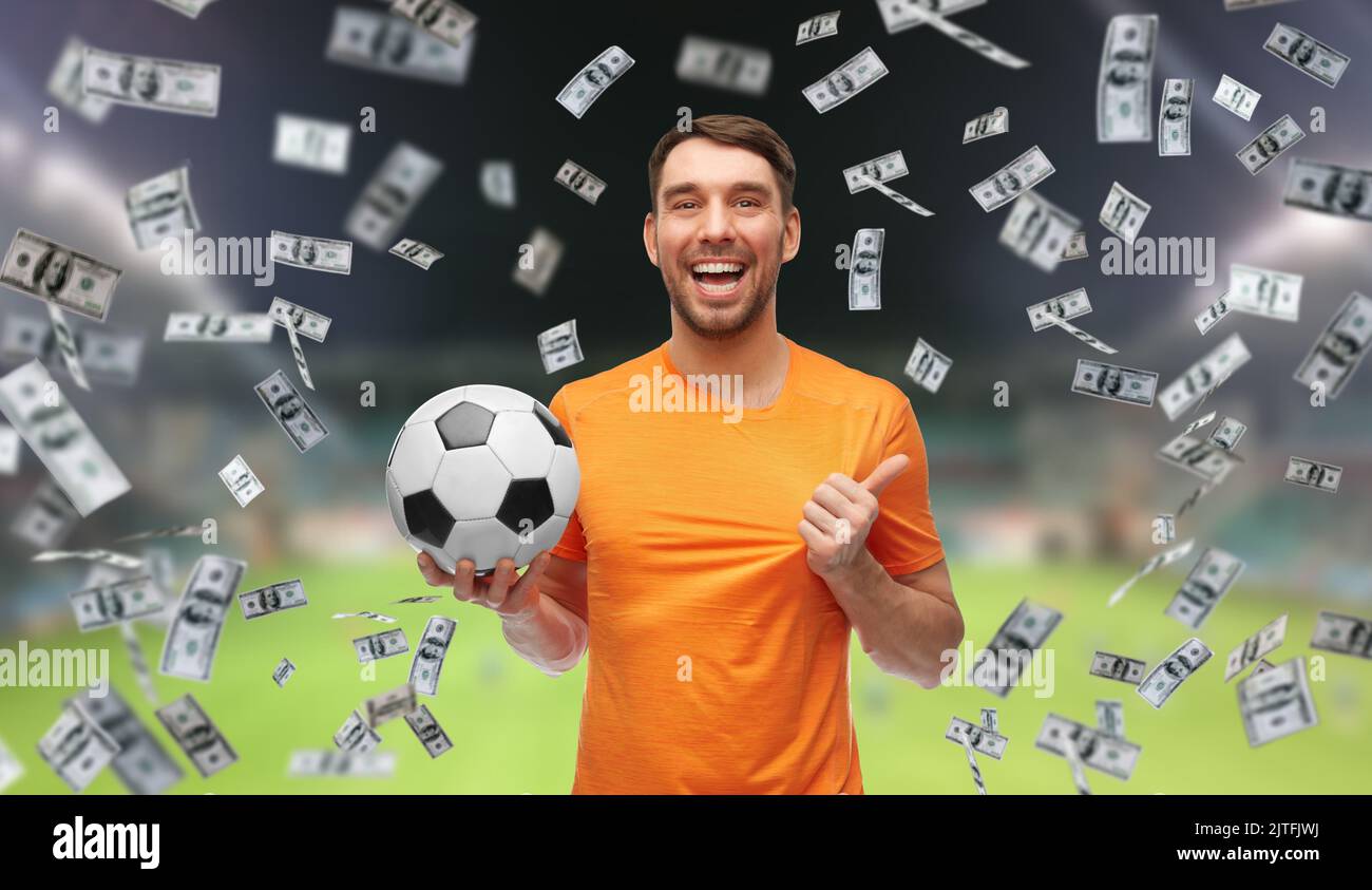 happy man with soccer ball over money Stock Photo - Alamy