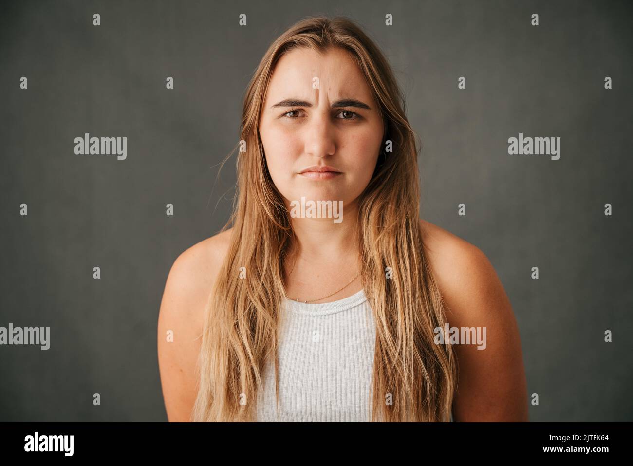 Close up suspicious woman frowning hi-res stock photography and images ...