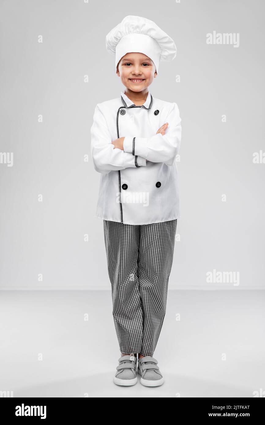 smiling little girl in chef's toque and jacket Stock Photo - Alamy