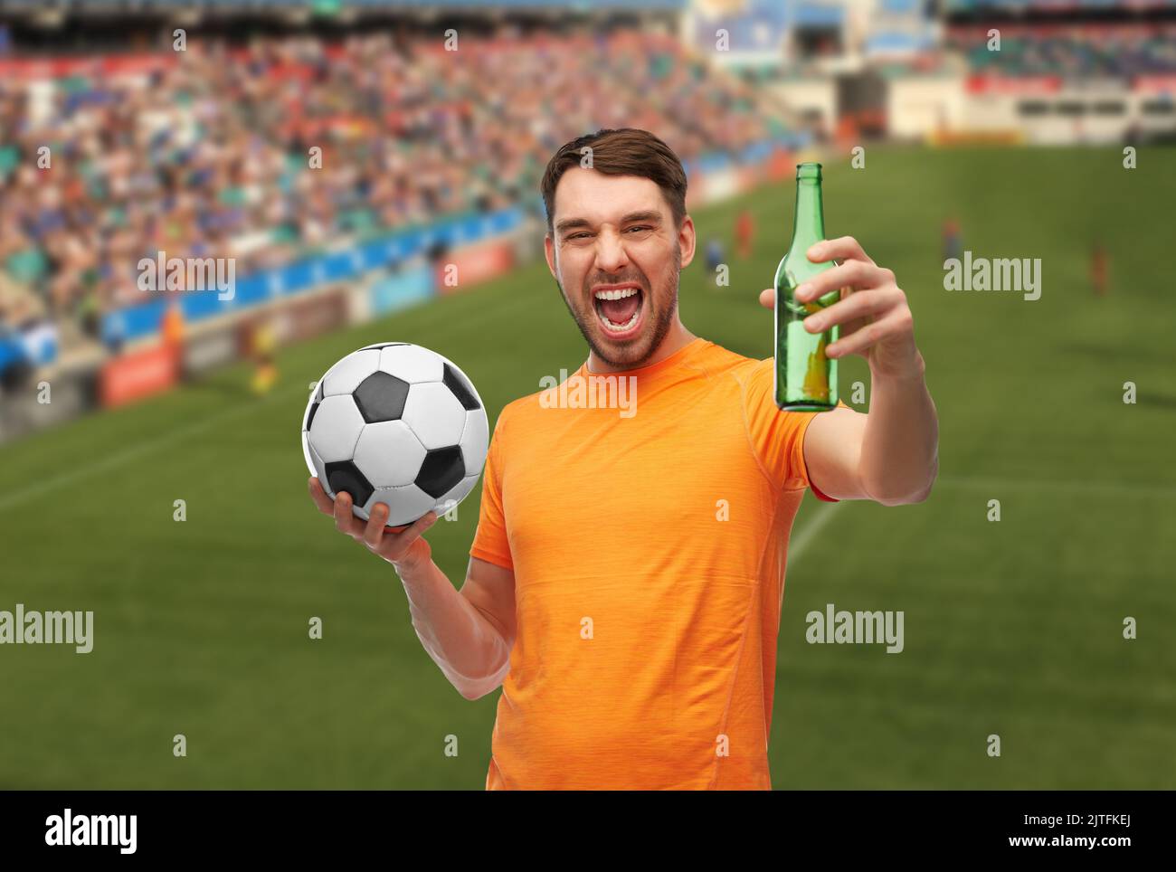 happy football fan with soccer ball and beer Stock Photo - Alamy