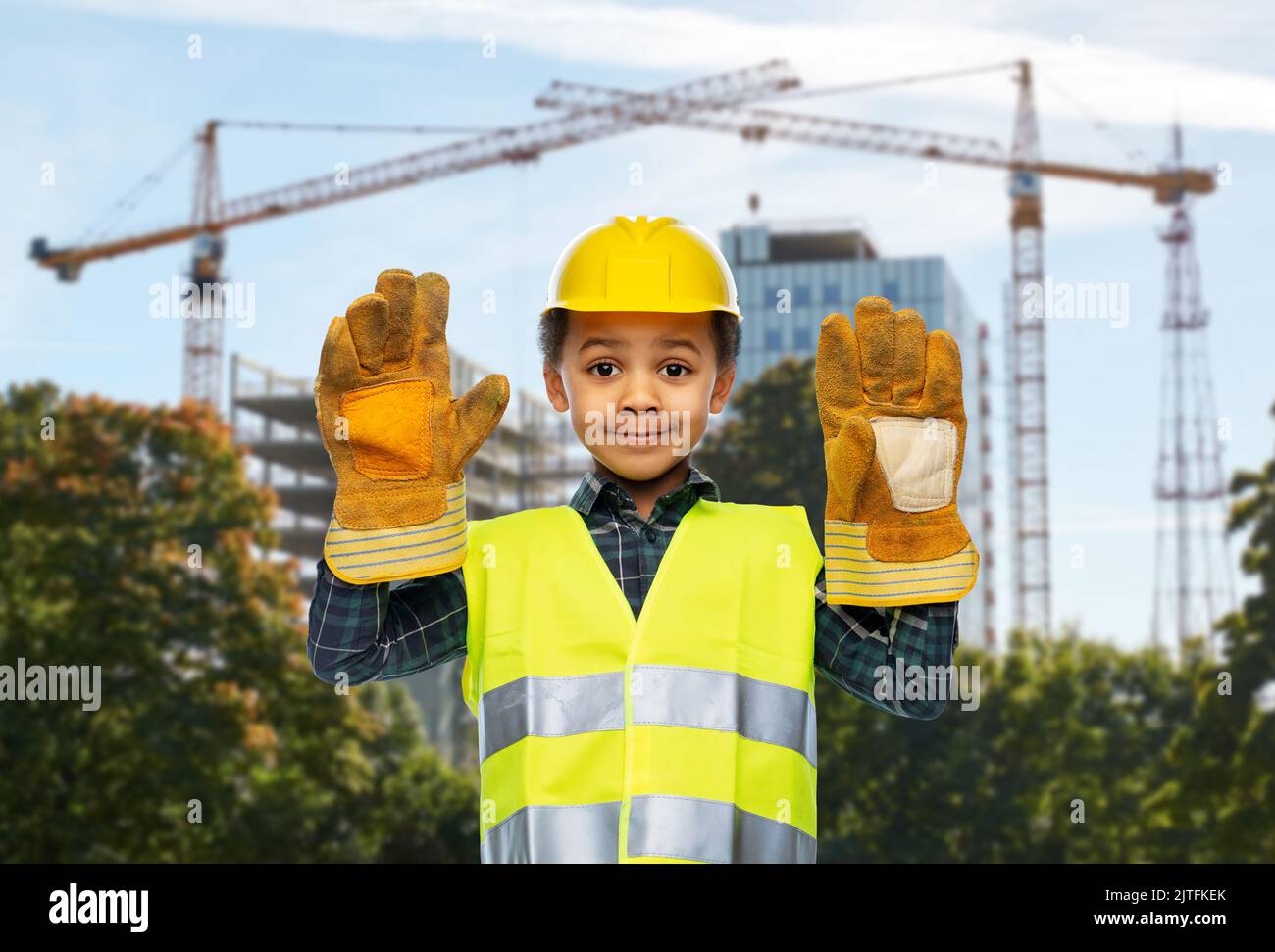 little boy in gloves, safety vest and helmet Stock Photo - Alamy