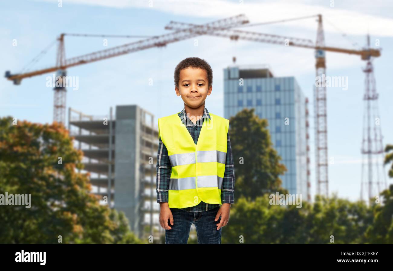 little boy in safety vest over construction site Stock Photo - Alamy