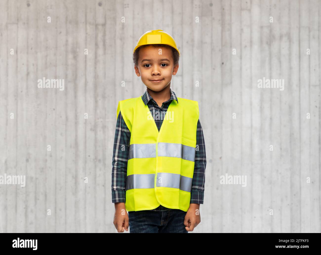 little boy in safety vest and construction helmet Stock Photo - Alamy