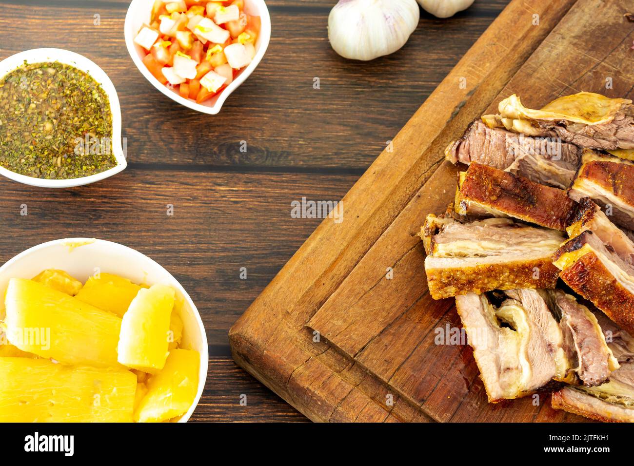 sliced beef ribs on a traditional brazilian barbecue, with side dishes ...