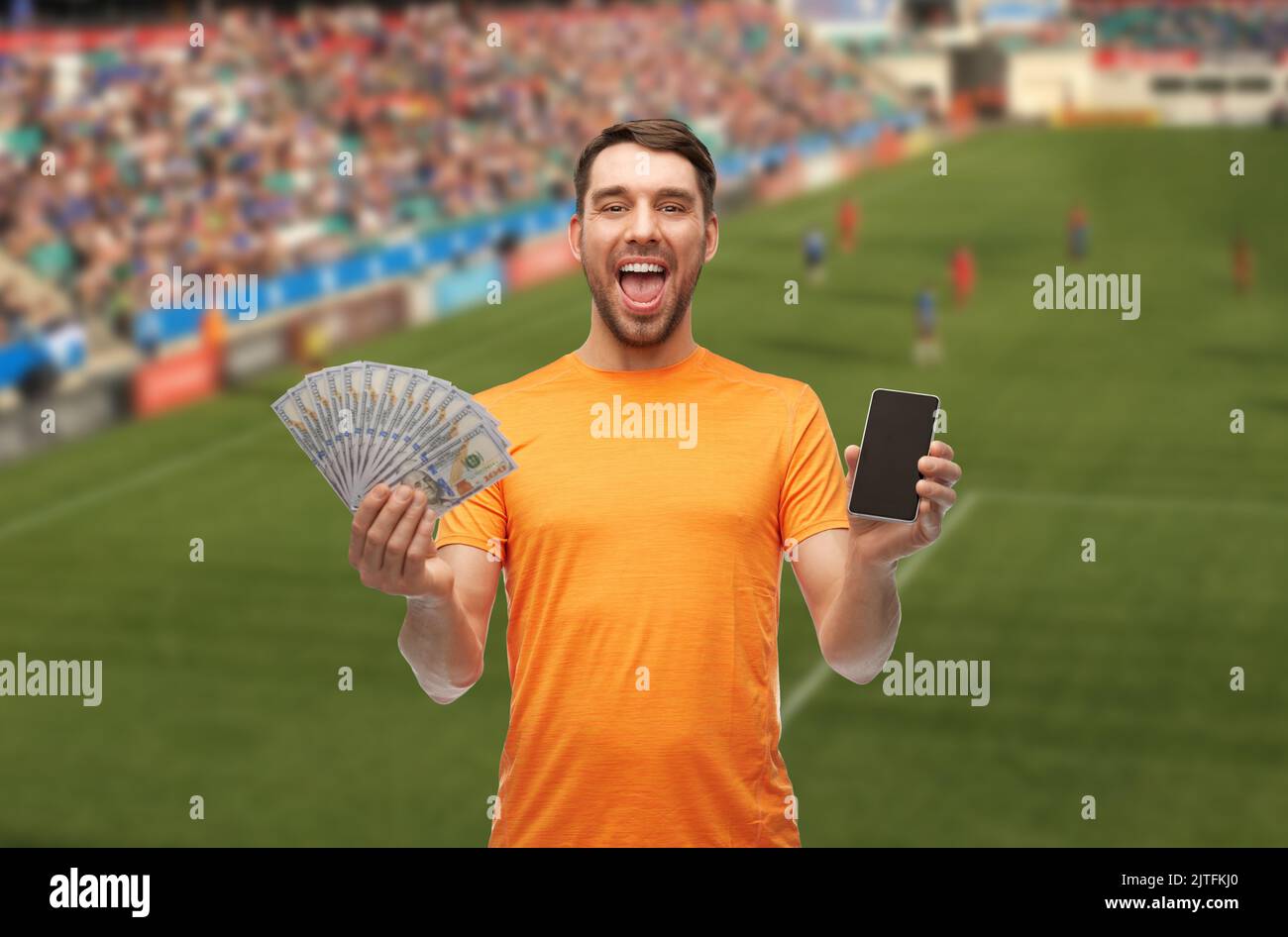 happy laughing man holding smartphone and money Stock Photo - Alamy