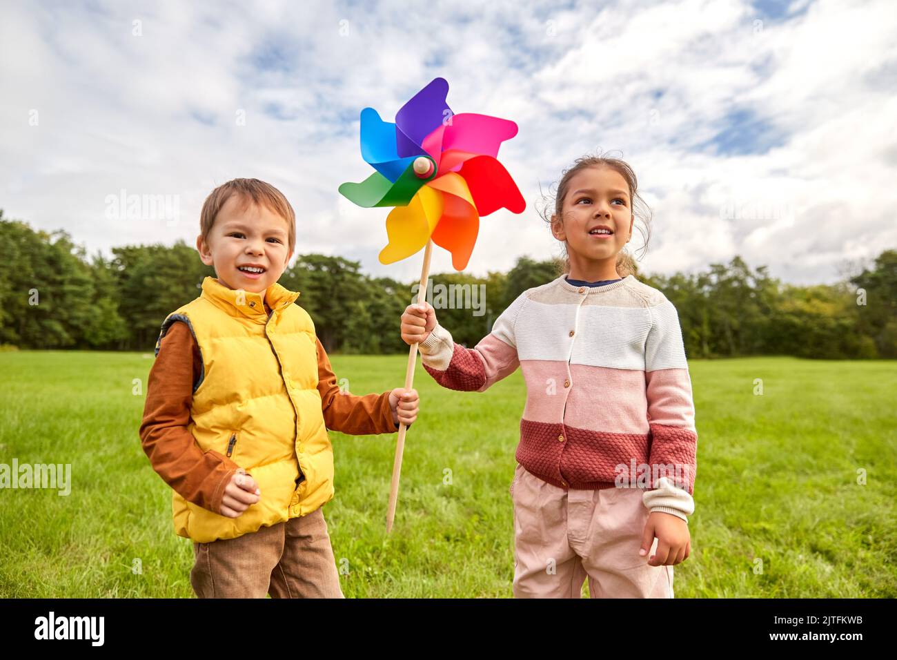 happy children playing with pinwheel at park Stock Photo - Alamy