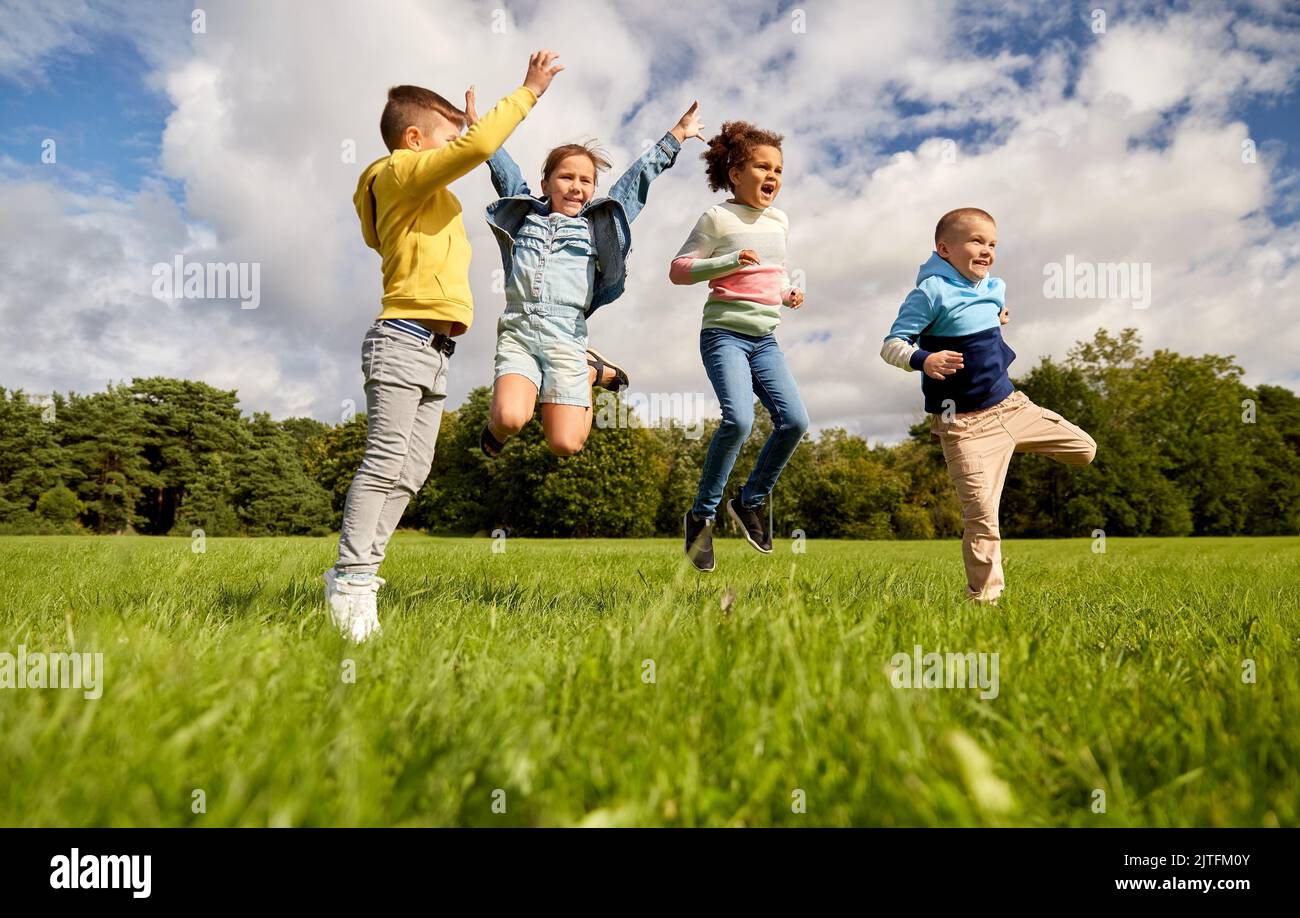 happy children jumping at park Stock Photo - Alamy