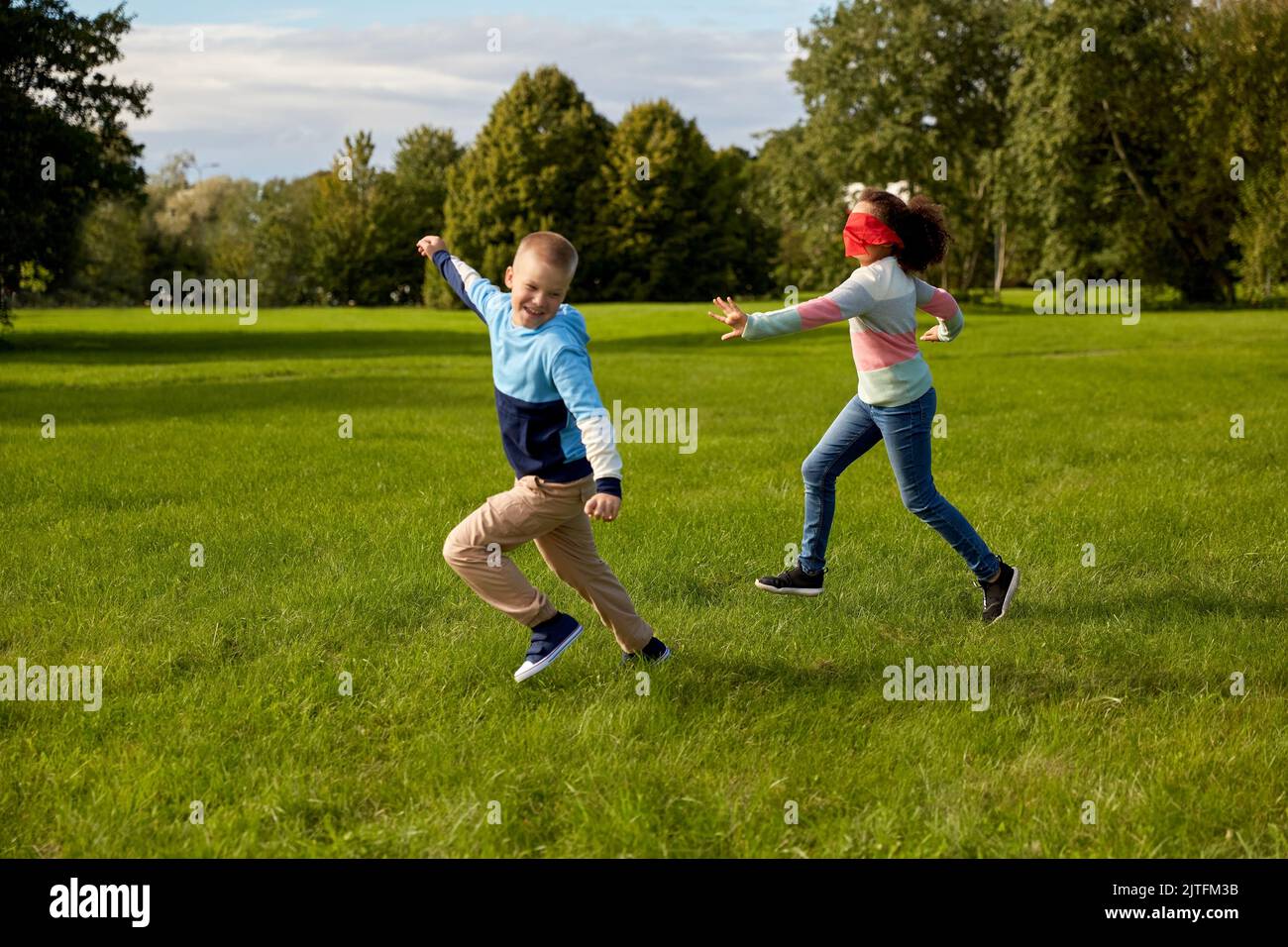 happy children playing and running at park Stock Photo - Alamy