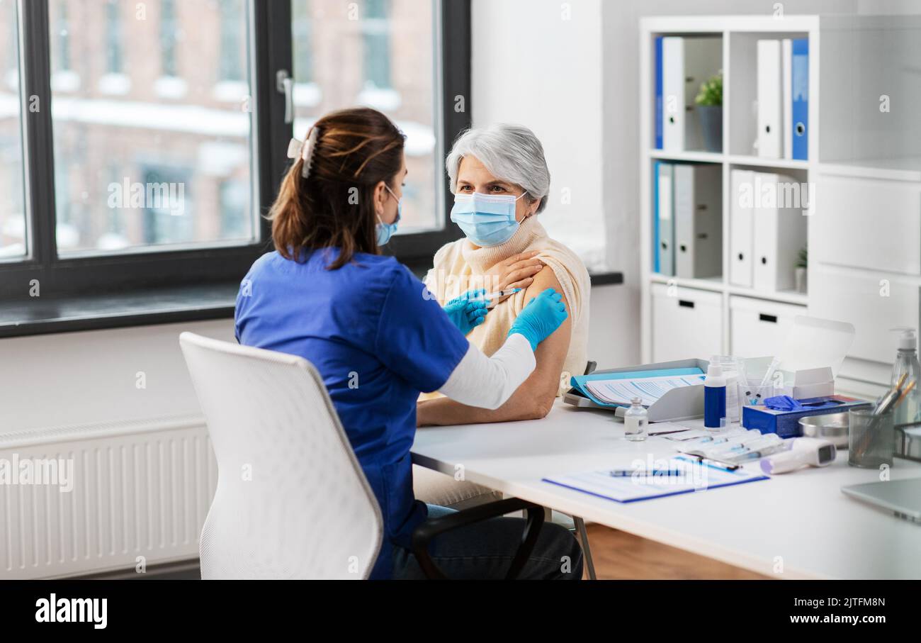 nurse with syringe making injection to woman Stock Photo - Alamy