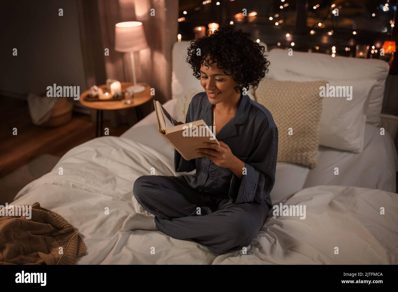 Woman reading book in bed night hi-res stock photography and images - Alamy