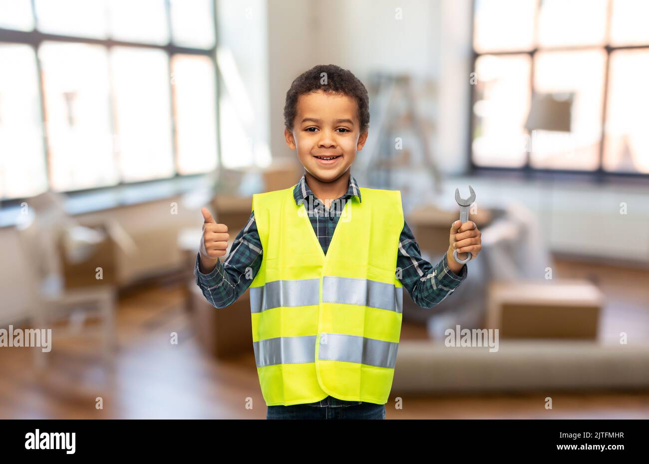 little boy in safety vest with wrench at home Stock Photo - Alamy