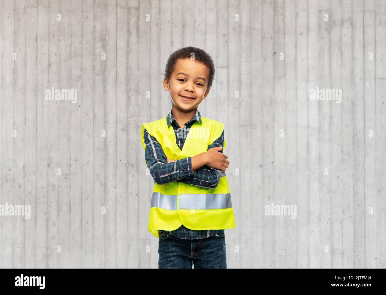 little boy in safety vest with crossed arms Stock Photo - Alamy
