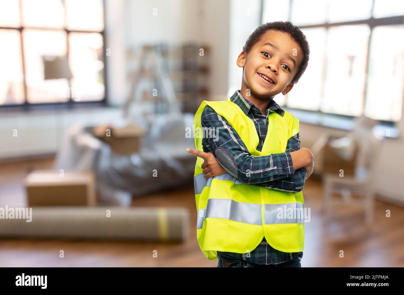 boy in safety vest with crossed arms at home Stock Photo - Alamy