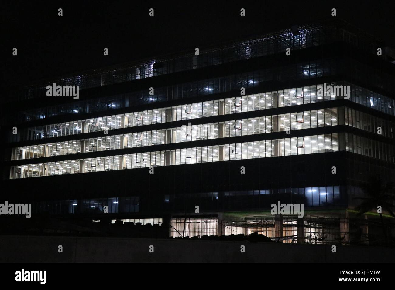 Building or workspace with full of lights illuminated during the night ...