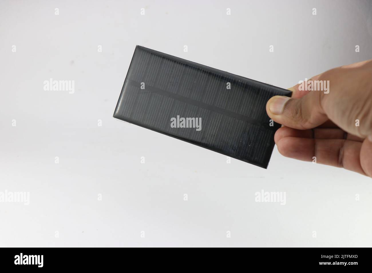 Solar panel or small solar cell held in hand made from silicon on a ...