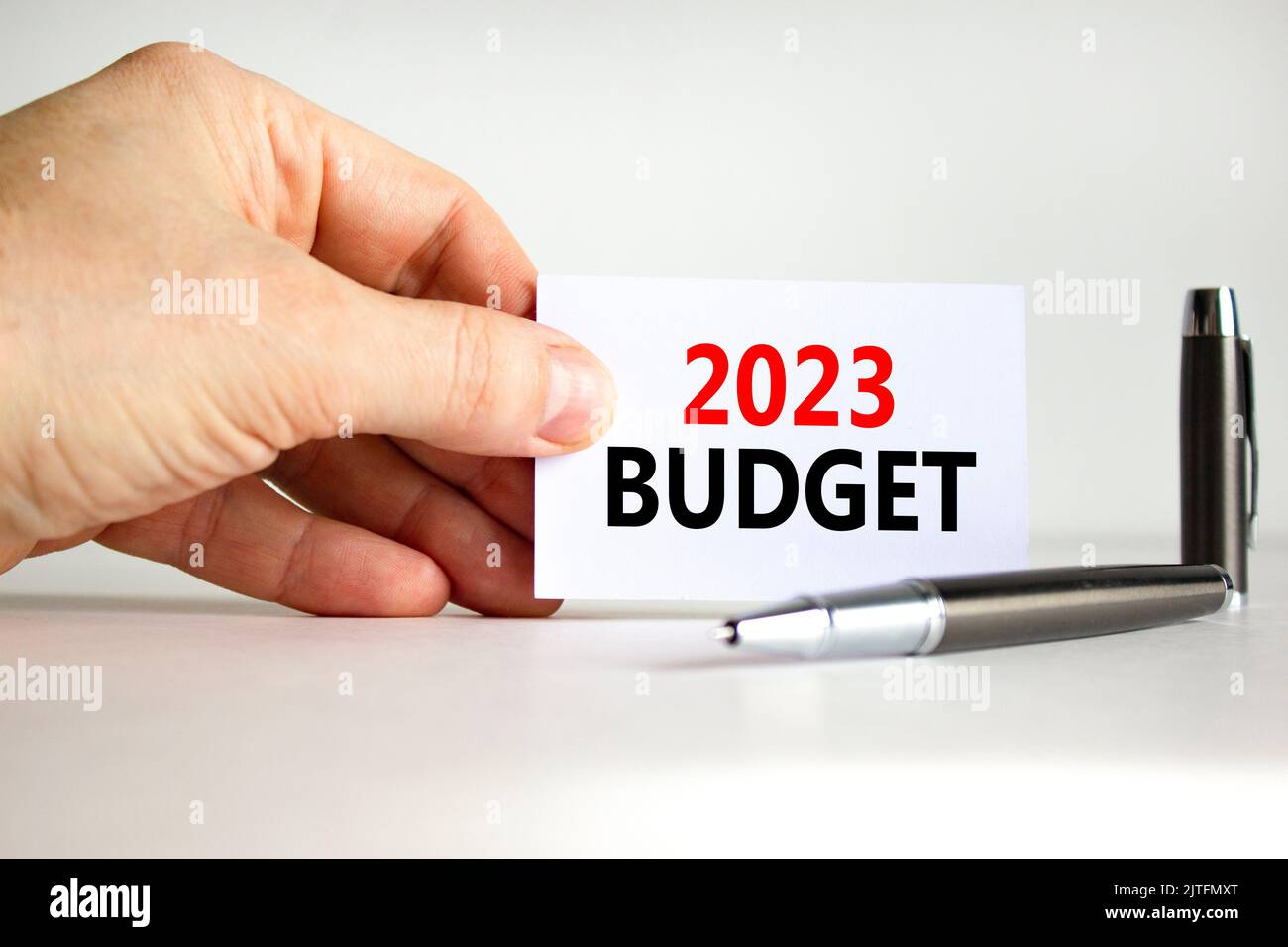 2023 Budget symbol. White card with words 2023 Budget. Businessman hand ...