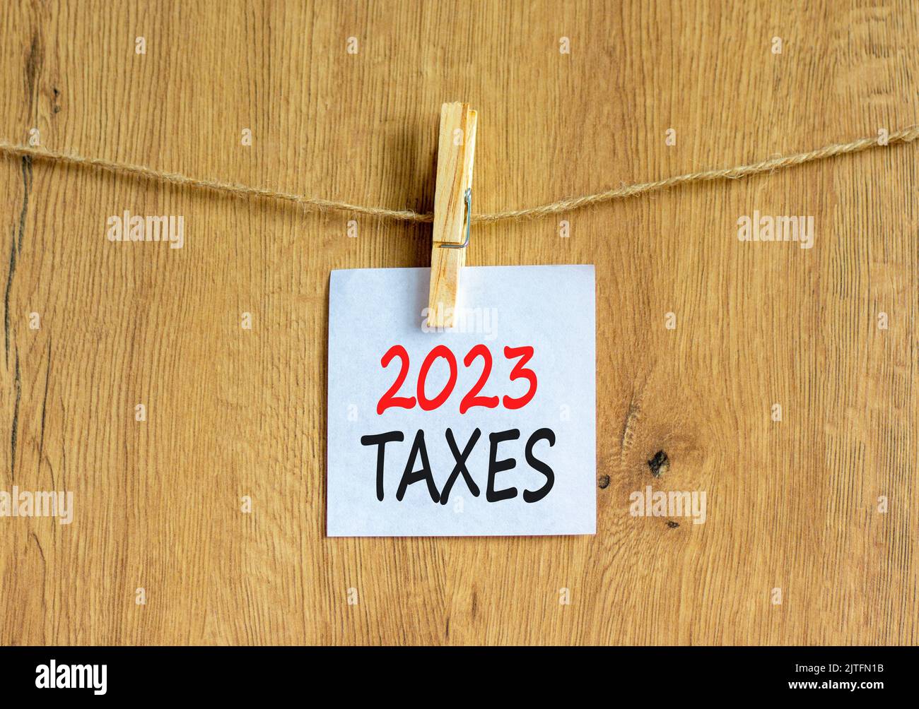 2023 taxes new year symbol. White paper with words 2023 taxes, clip on ...