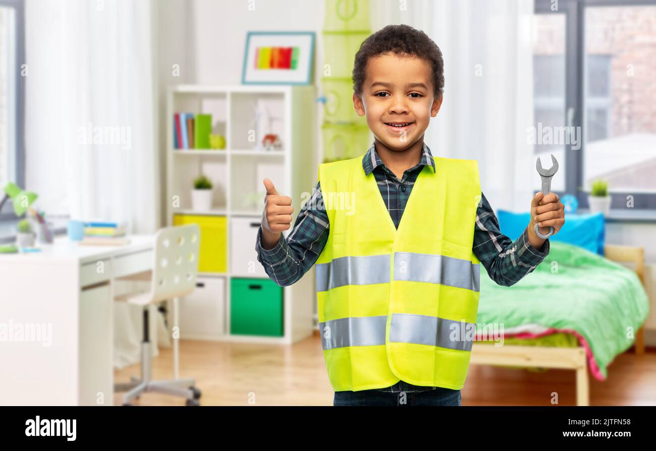 little boy in safety vest with wrench at home Stock Photo - Alamy
