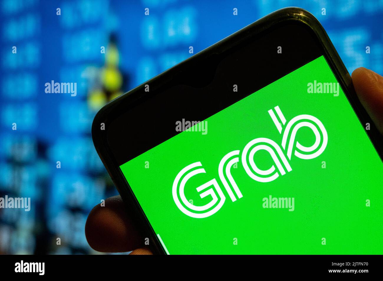 In this photo illustration, the Singapore technology ride-sharing and ...