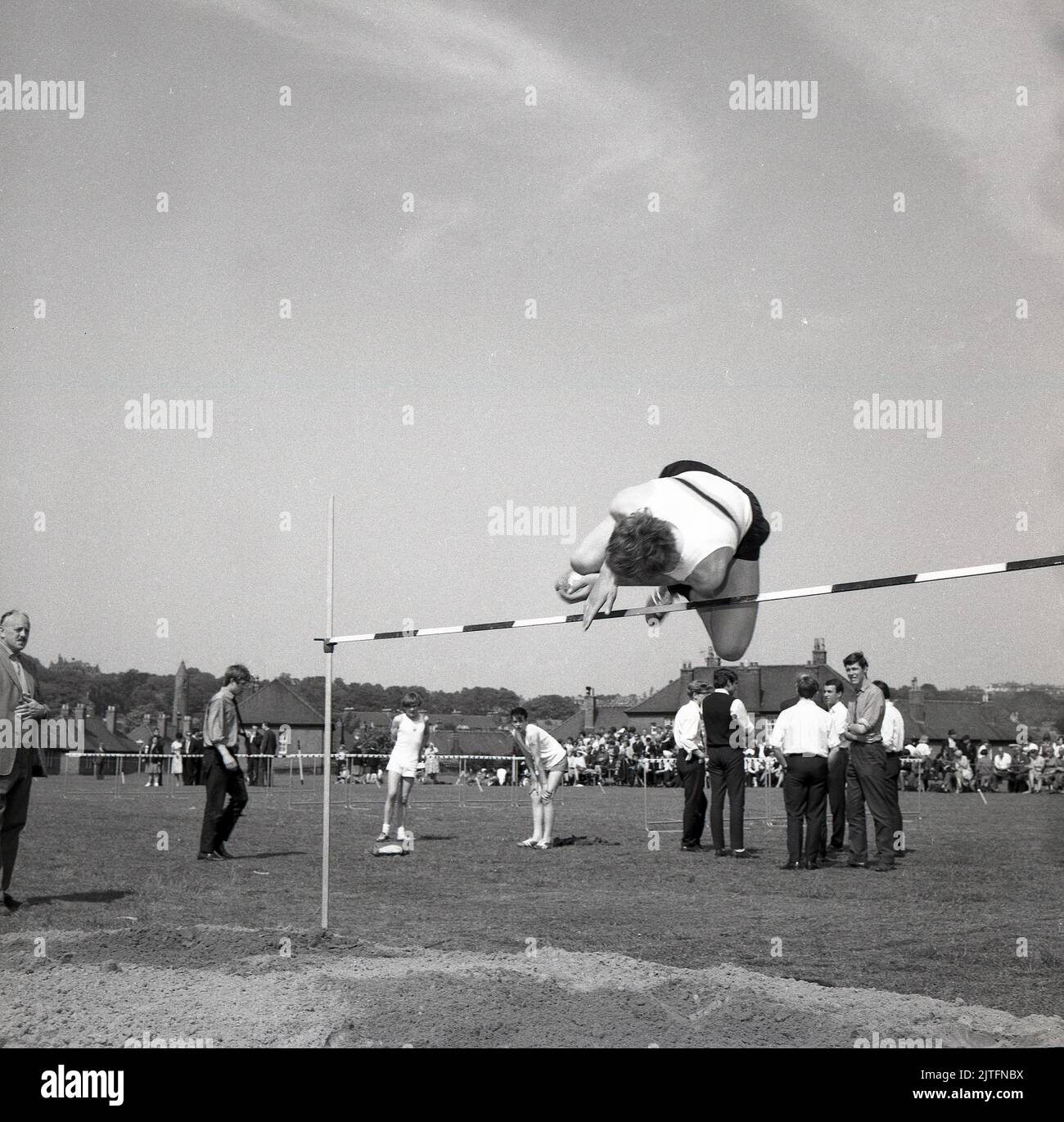 1960s, historical, outside at a county sports event, a boy doing the ...