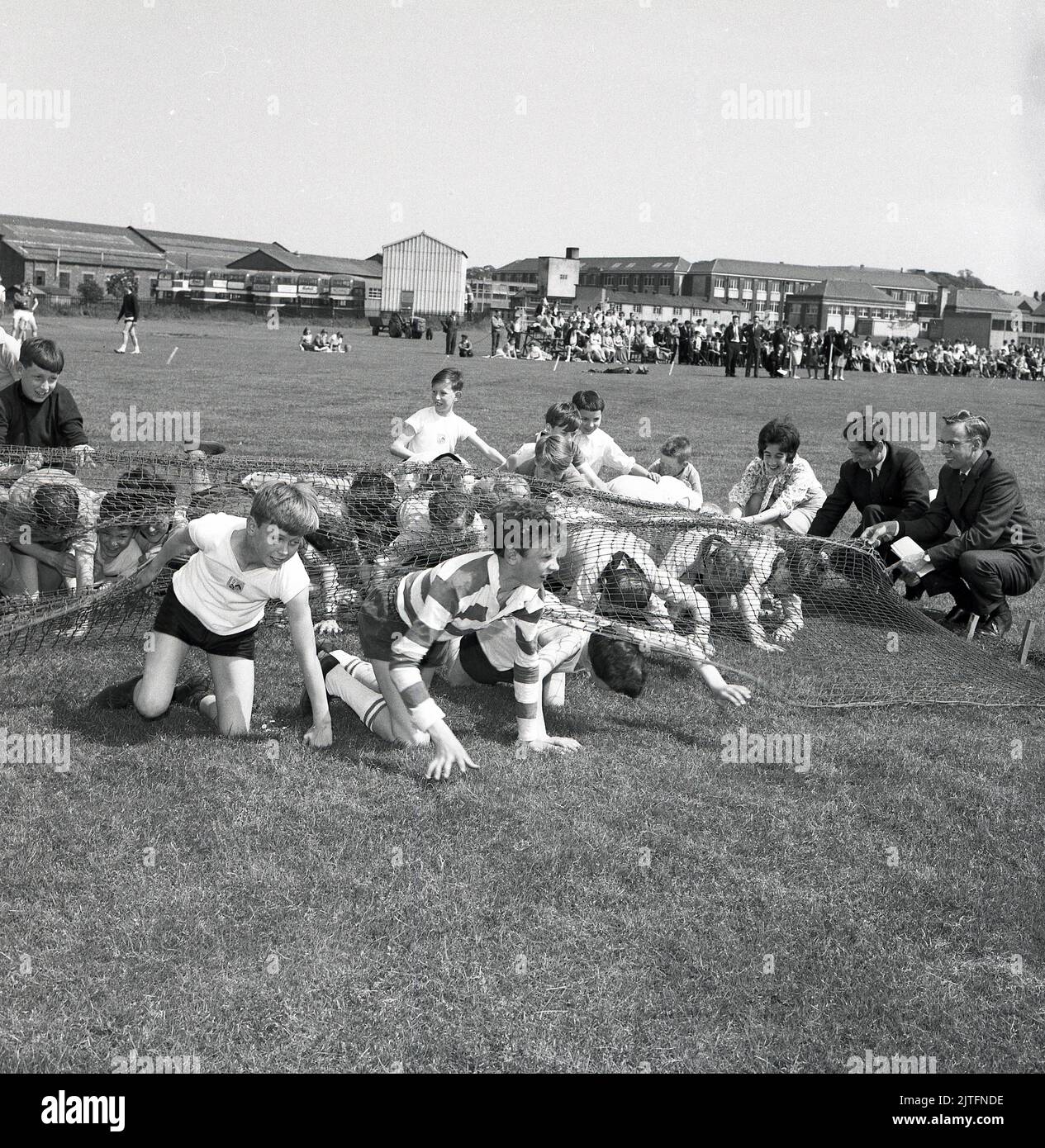 1960s, historical, outside in a field at a school sports day, a group ...