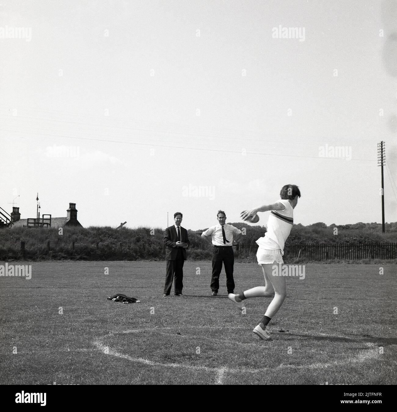 1960s, historical, school sports, outside in sports field, a teenage ...