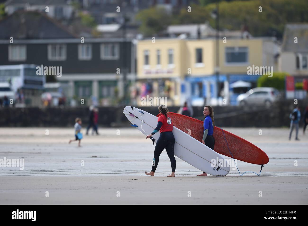 Surfers with long boards walking on the baech Stock Photo - Alamy